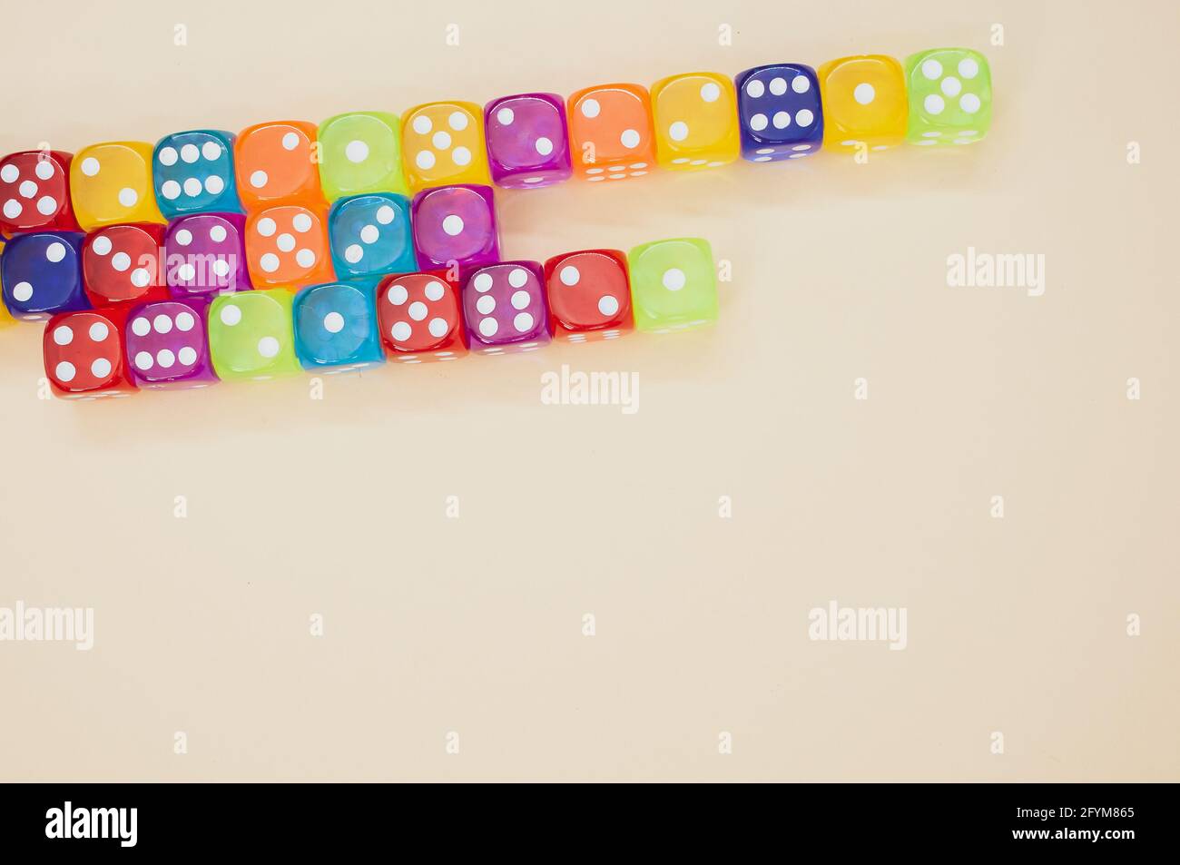 Dice in a row isolated on a beige background Stock Photo - Alamy