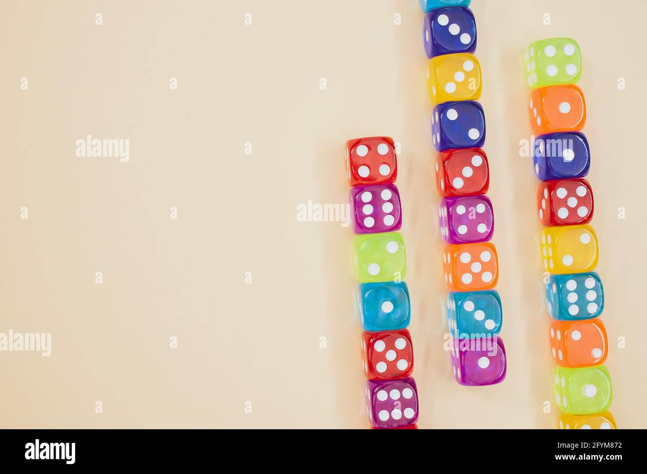 Dice in a row isolated on a beige background Stock Photo - Alamy