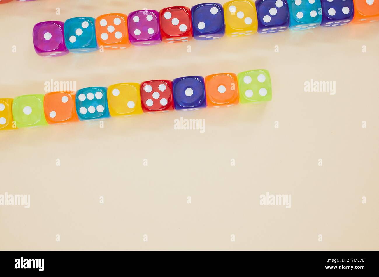 Dice in a row isolated on a beige background Stock Photo - Alamy