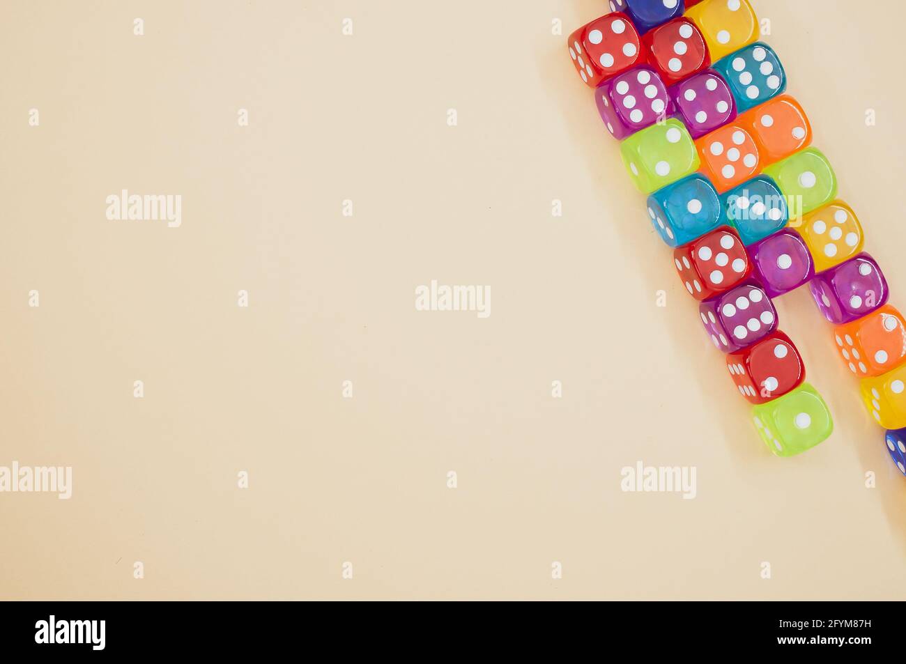 Dice in a row isolated on a beige background Stock Photo - Alamy