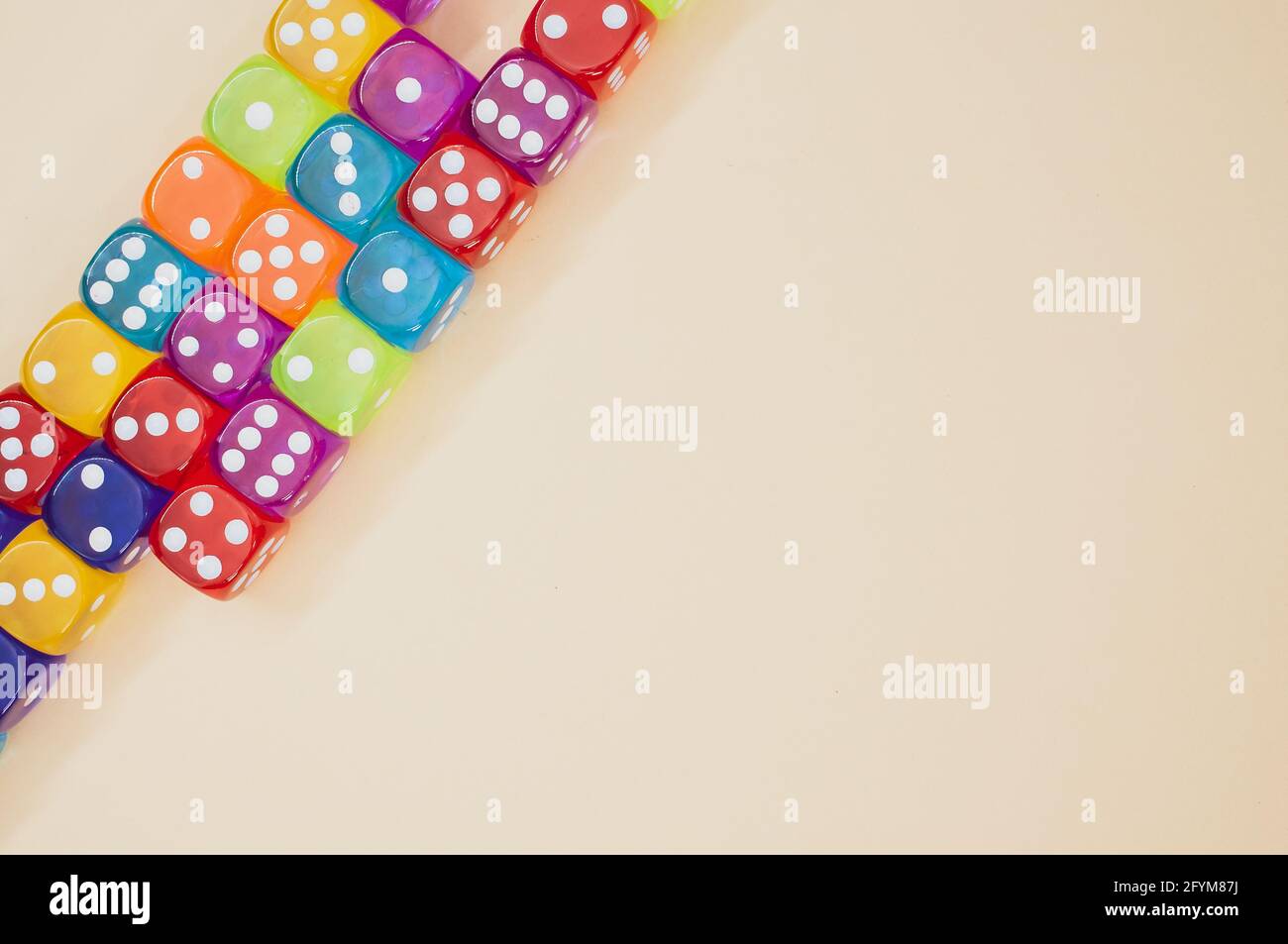 Dice in a row isolated on a beige background Stock Photo - Alamy