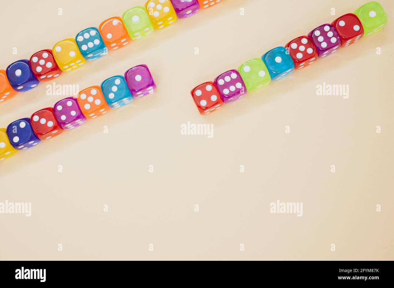 Dice in a row isolated on a beige background Stock Photo - Alamy