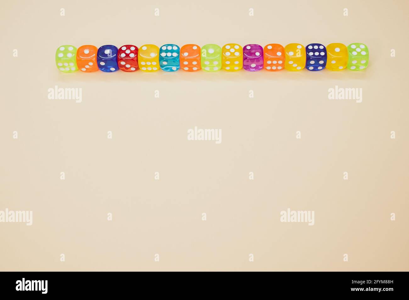 Dice in a row isolated on a beige background Stock Photo - Alamy