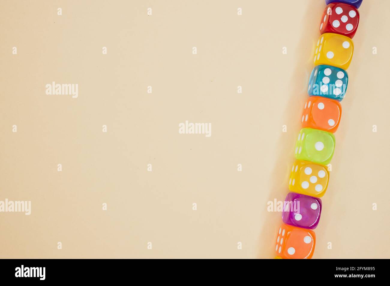 Dice in a row isolated on a beige background Stock Photo - Alamy