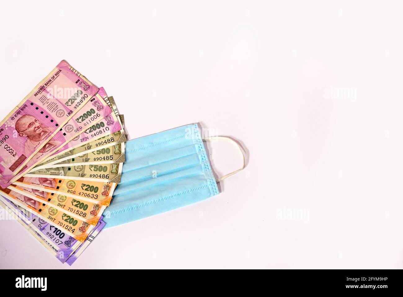 Indian rupee and protective face masks isolated on white background ...