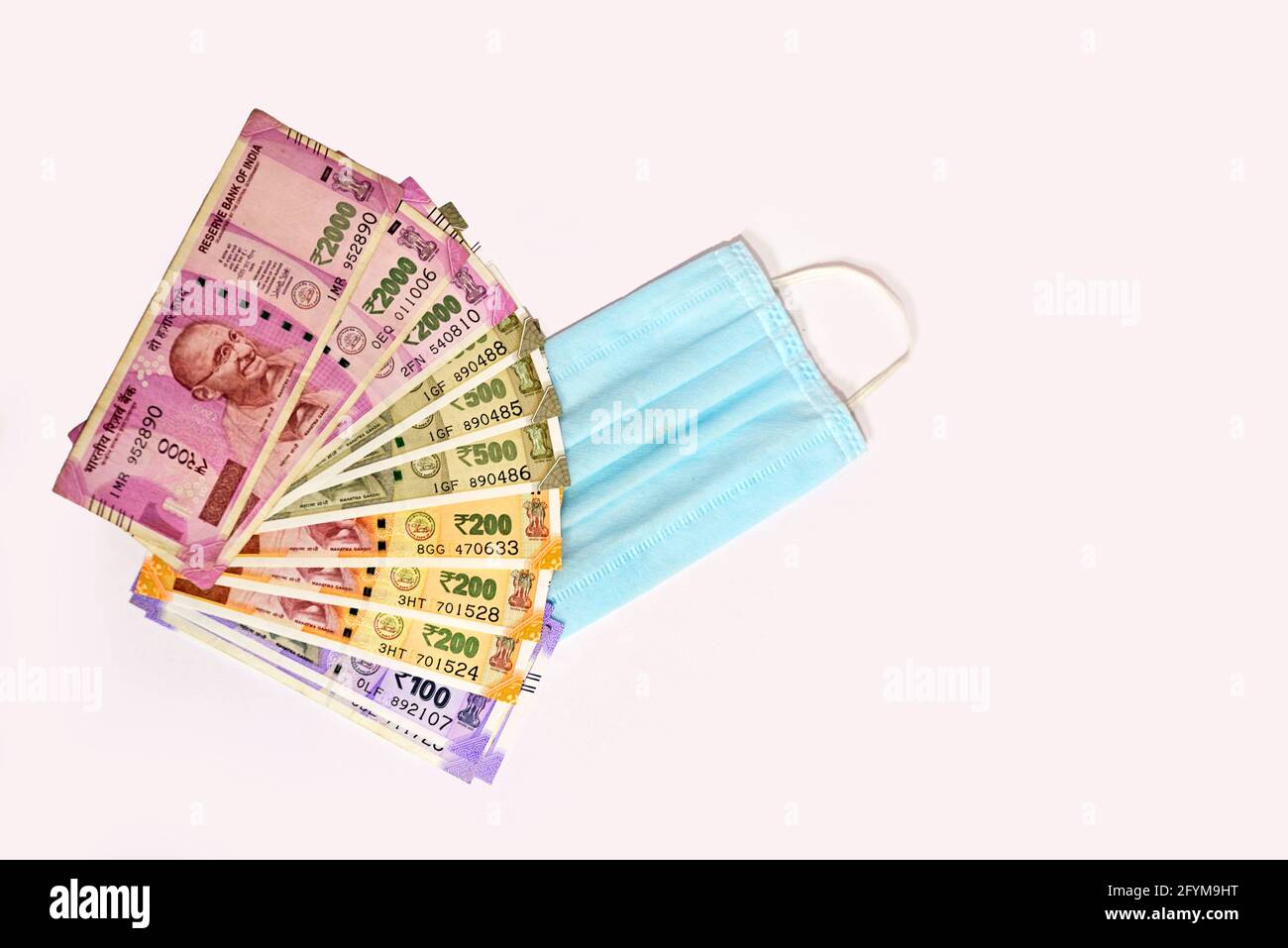 Indian rupee and protective face masks isolated on white background ...