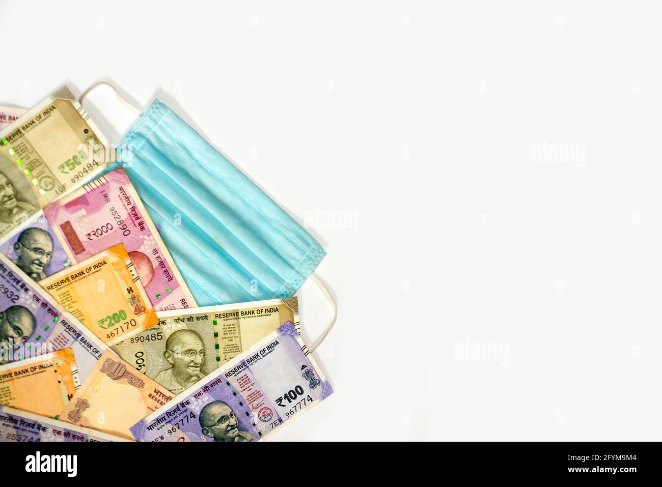 Indian rupee and protective face masks isolated on white background ...