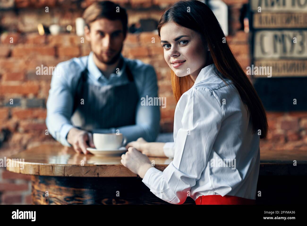 happy woman with cup of coffee and man bartender in apron Stock Photo ...
