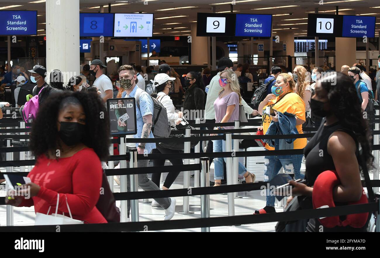 Orlando, United States. 28th May, 2021. Travelers wait in line at a ...