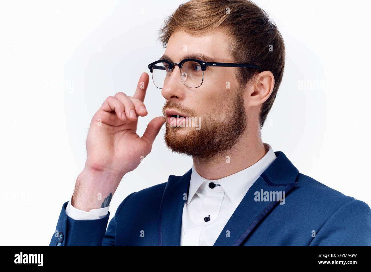 business man in a jacket and shirt straightens glasses on his face ...