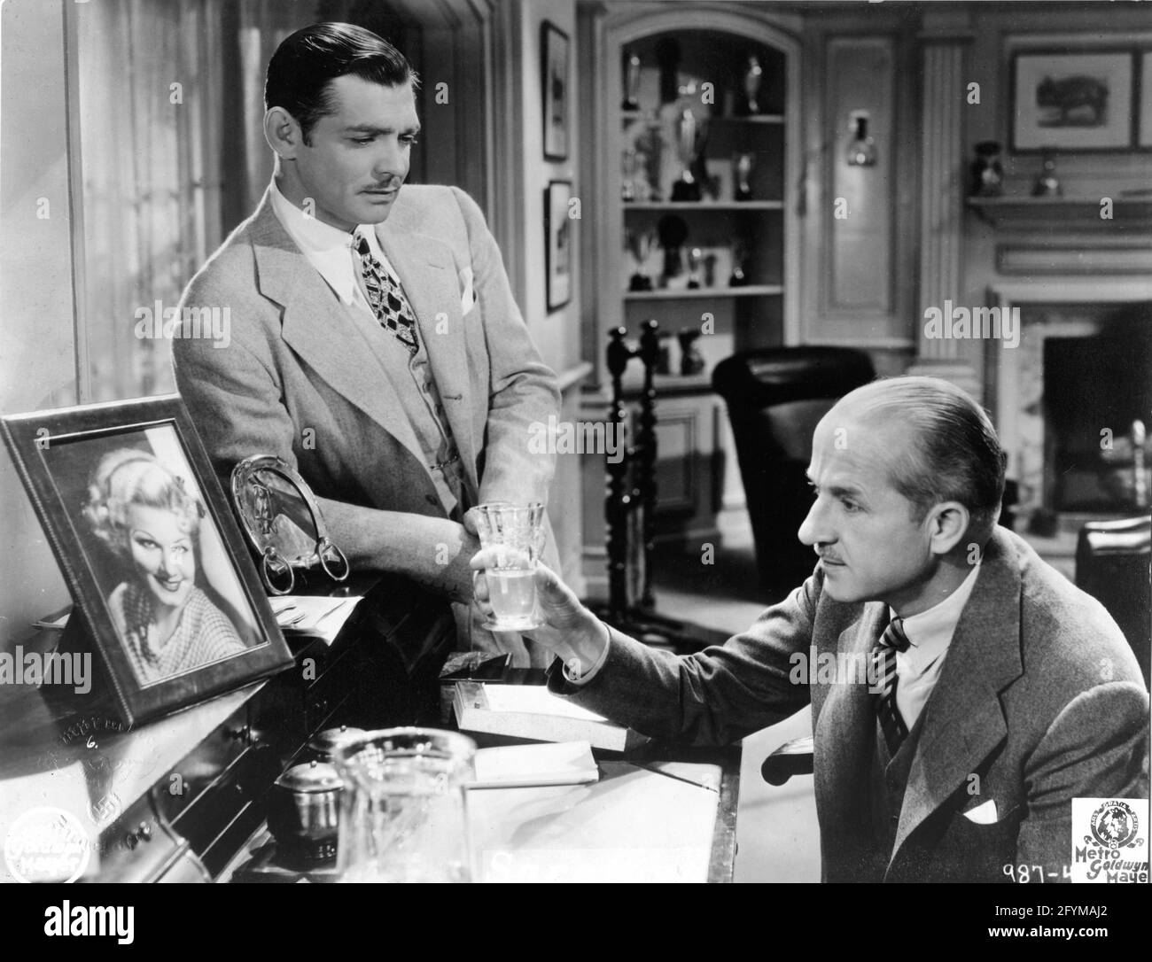 CLARK GABLE and JONATHAN HALE (toasting a portrait of JEAN HARLOW) in SARATOGA 1937 director ...
