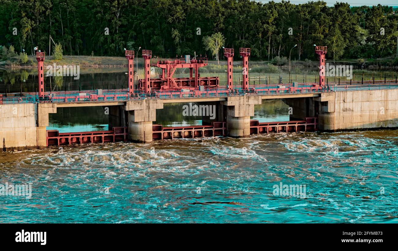River, dam, bridge. Car and pedestrian bridge in the morning. A full ...