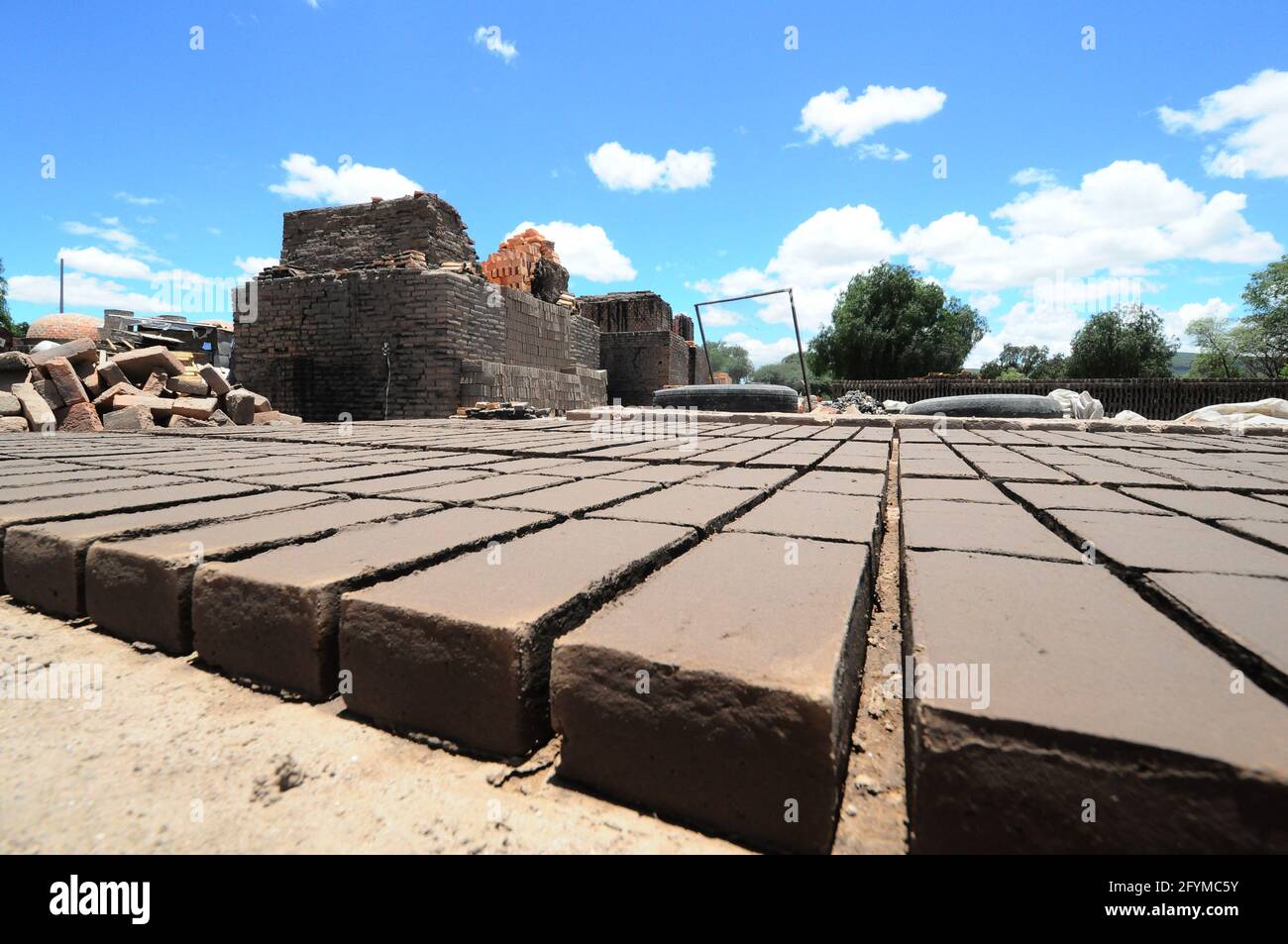 A worker is seen during the production of clay partitions, handmade ...