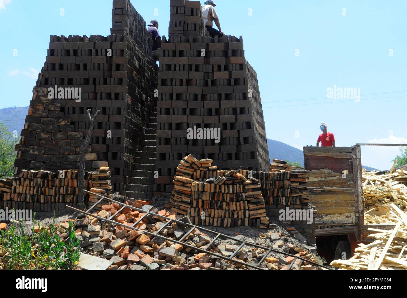A worker is seen during the production of clay partitions, handmade ...