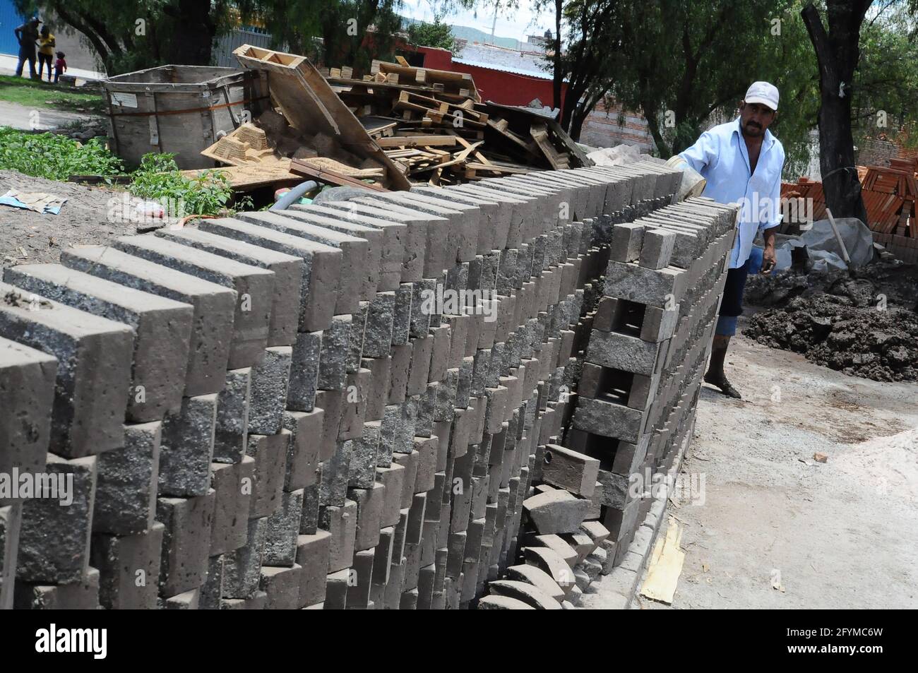 A worker is seen during the production of clay partitions, handmade ...