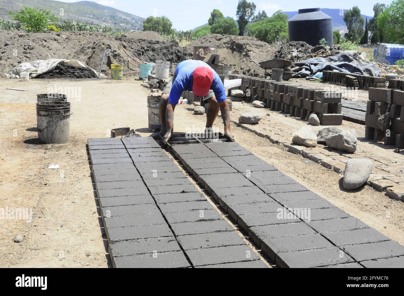 A worker is seen during the production of clay partitions, handmade ...