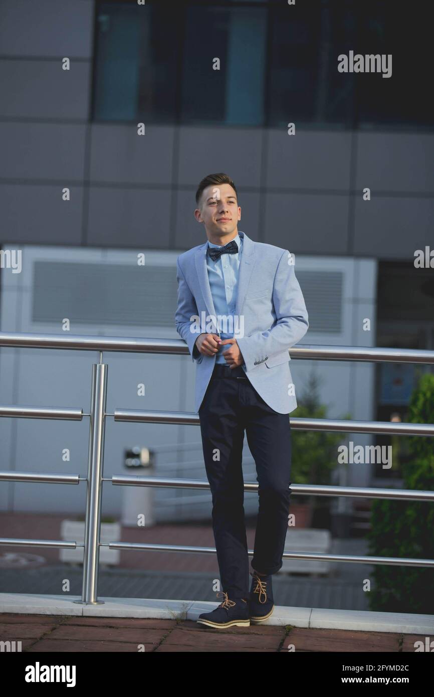 Vertical shot of a young male model posing in a light blue suit and a ...