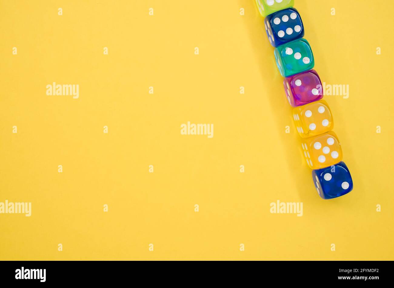 Dice in a row isolated on a yellow background Stock Photo - Alamy