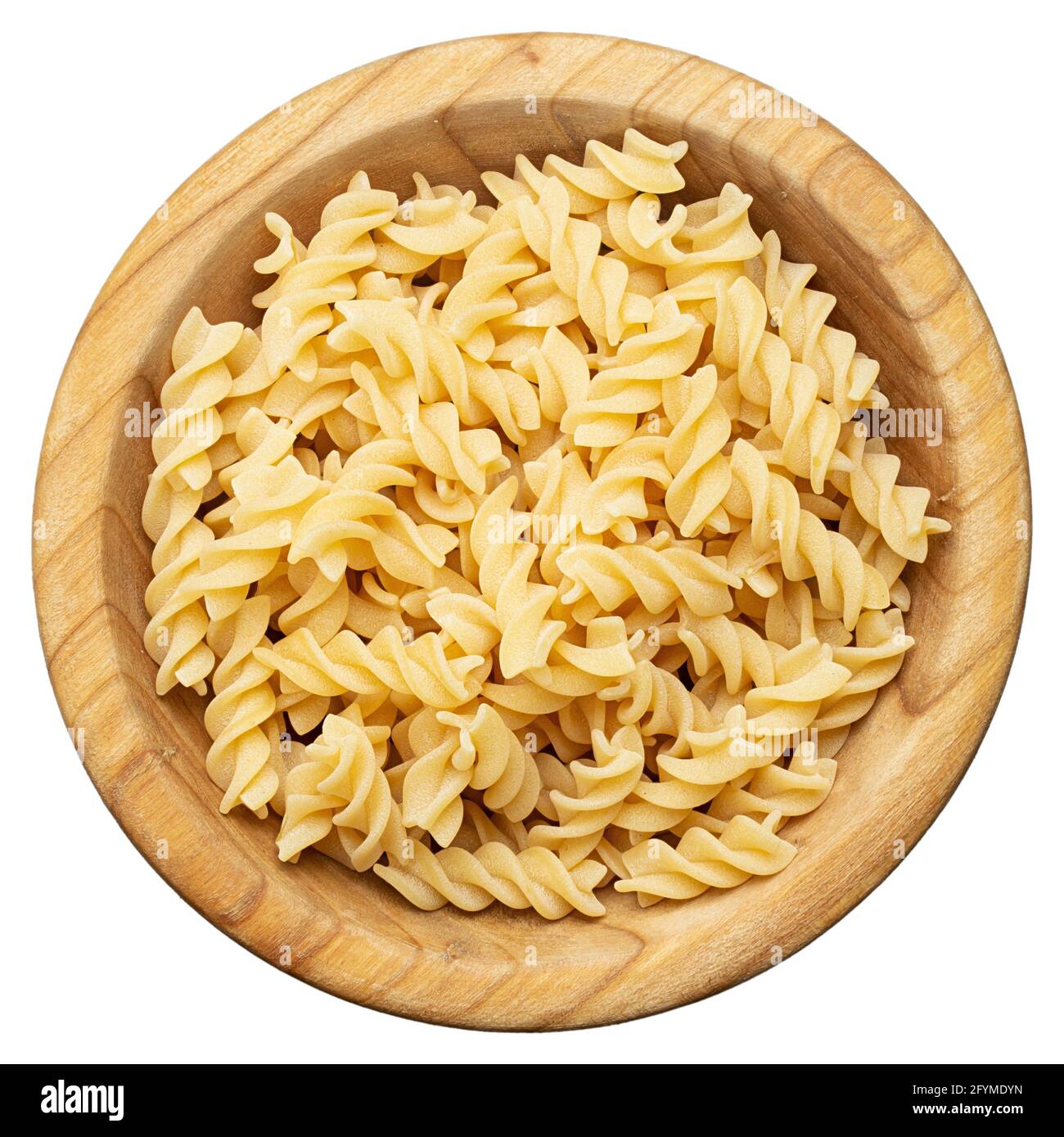 Raw fusilli pasta in a wooden bowl isolated on white background. File ...