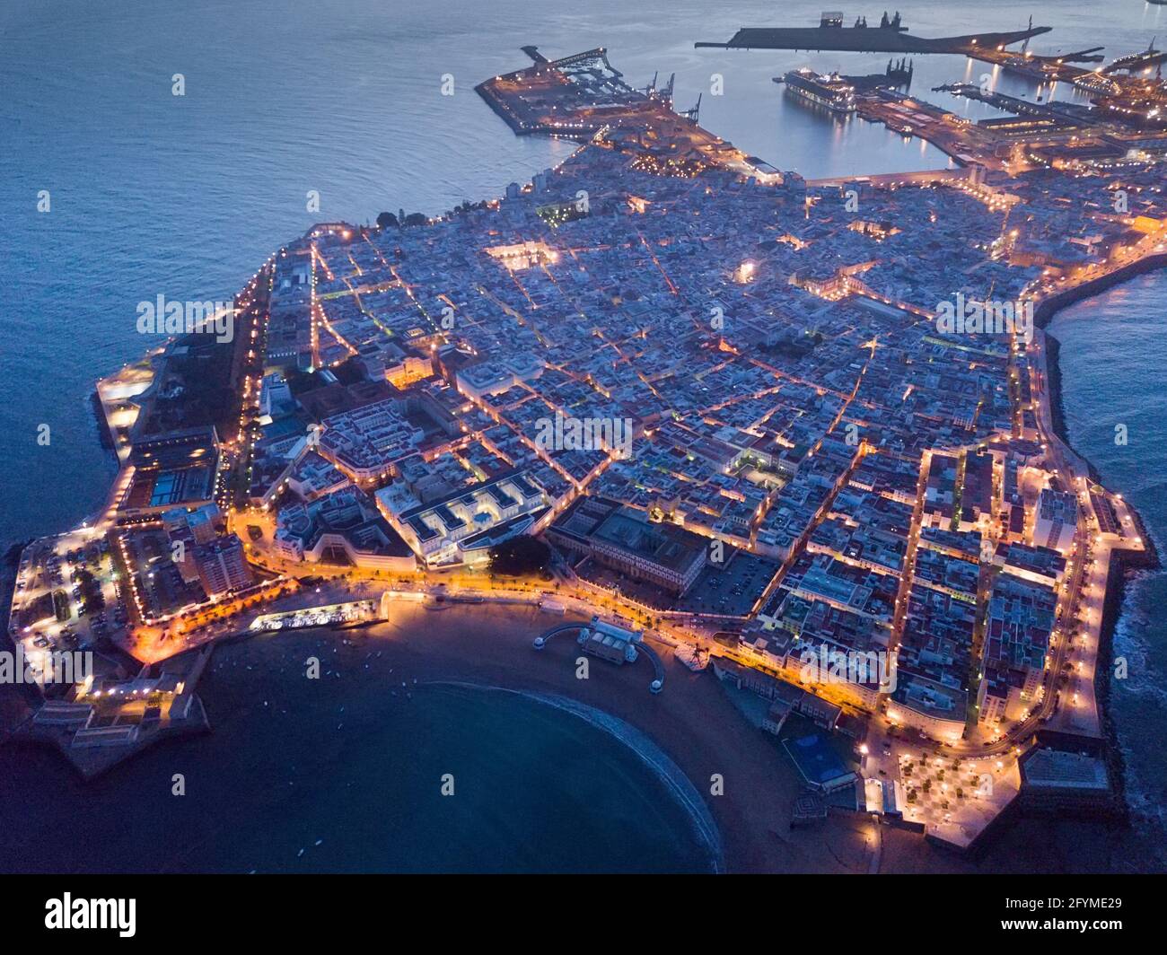 Night general aerial view of lighted Cadiz, Spanish port city ...