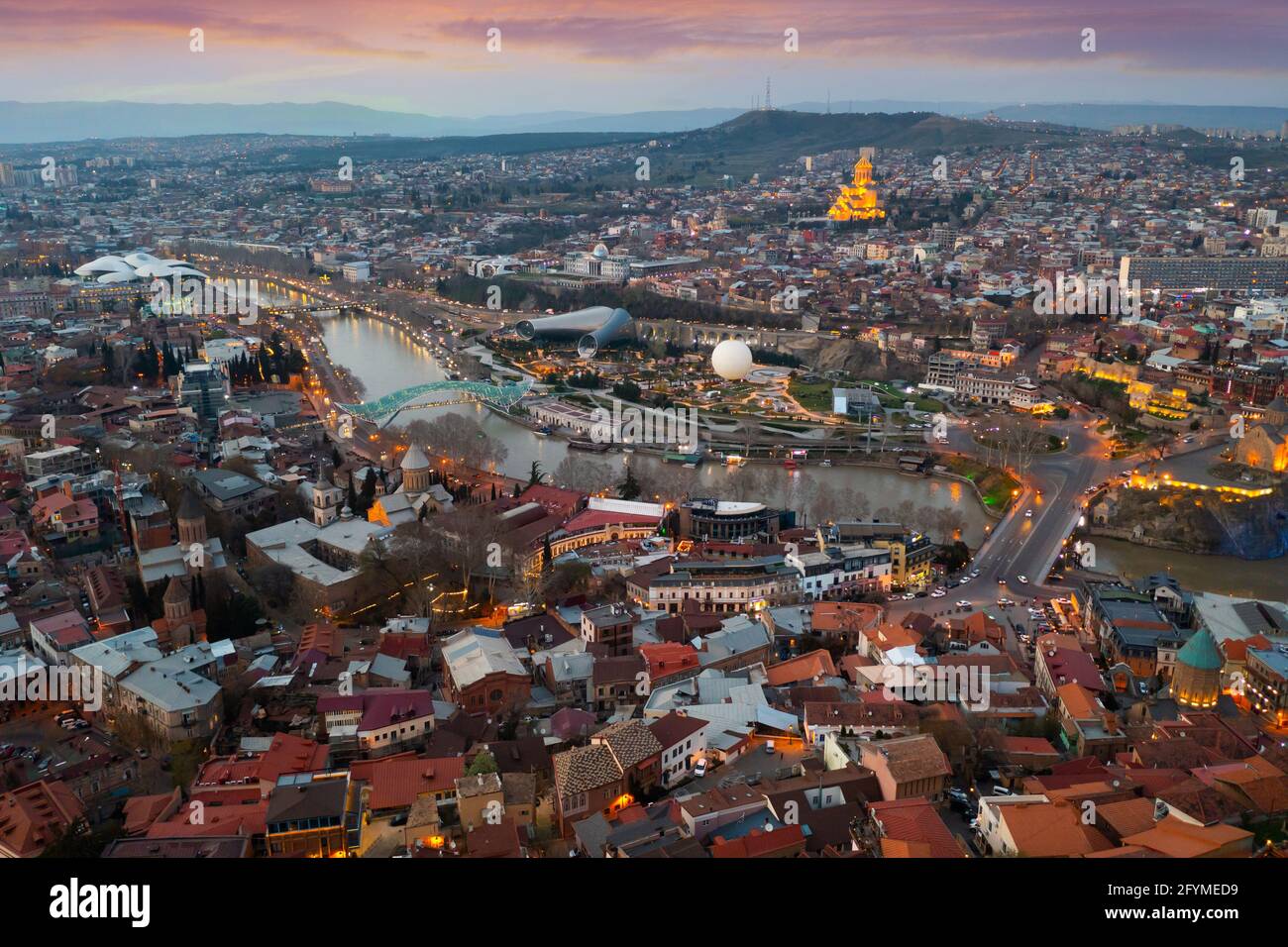 Scenic aerial view of historical area of Tbilisi on banks of Kura river ...