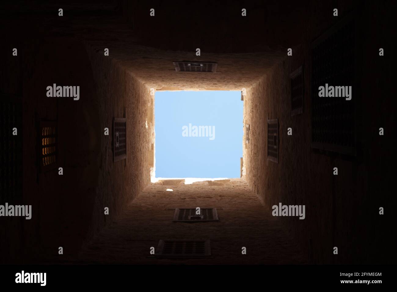 Square light window in dark tower interior, abstract architectural ...