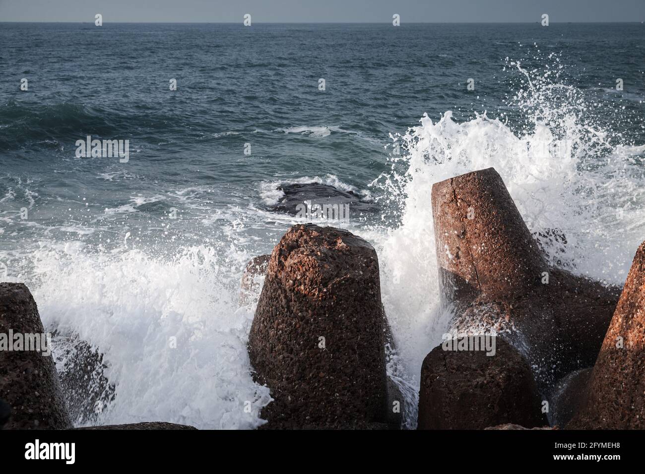 Concrete breakwater blocks with splashing waves. Mediterranean Sea ...