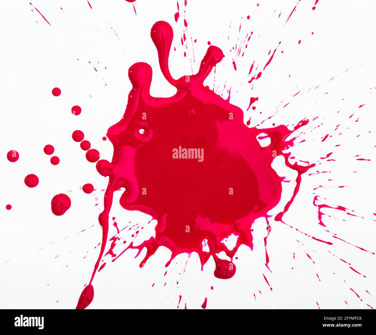 Splash and splatters of spilled paint of red color on white surface ...