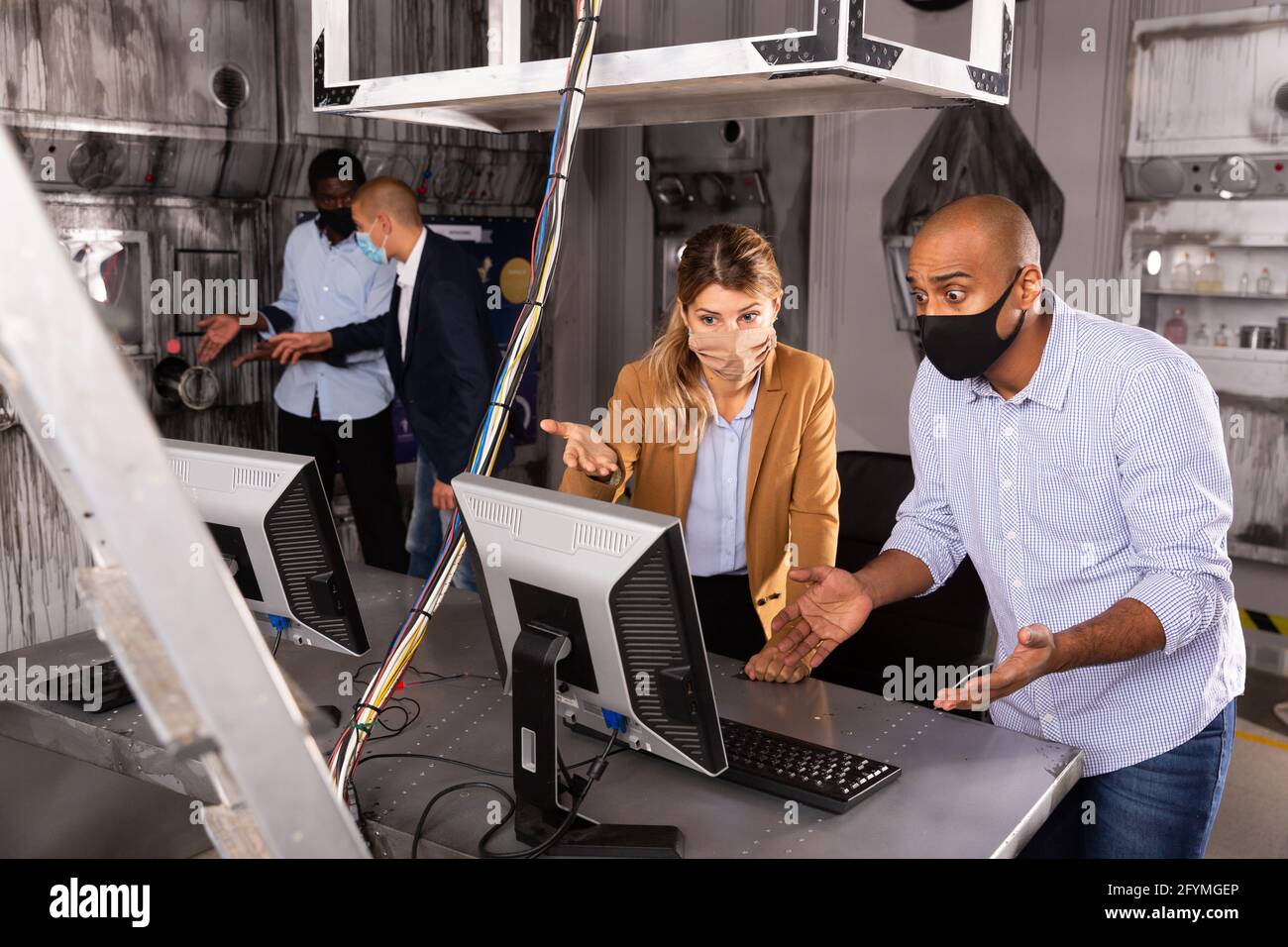 Man and woman in protective masks in panic looking for a solution on ...