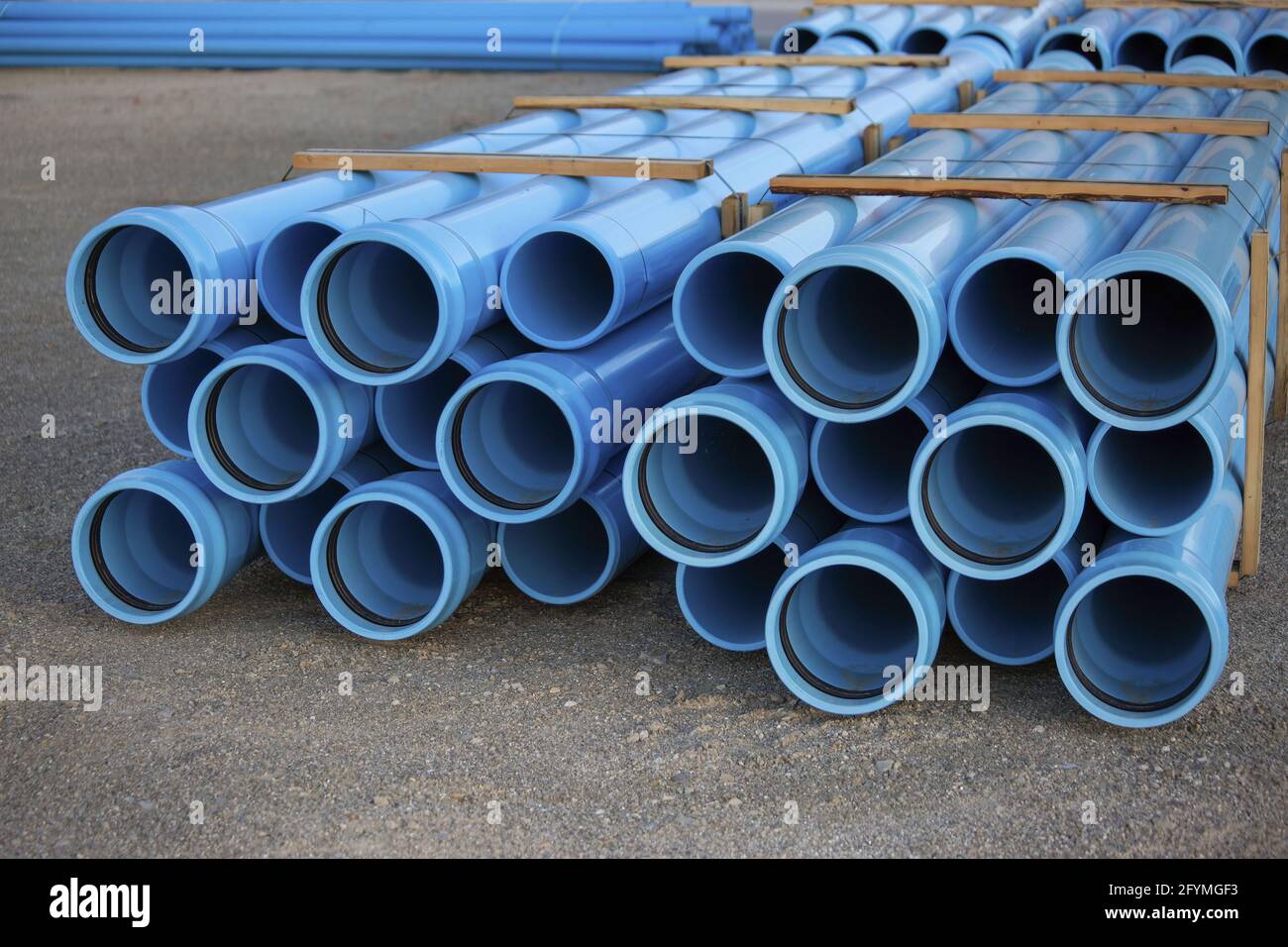 Rows of construction pipes on the ground Stock Photo - Alamy