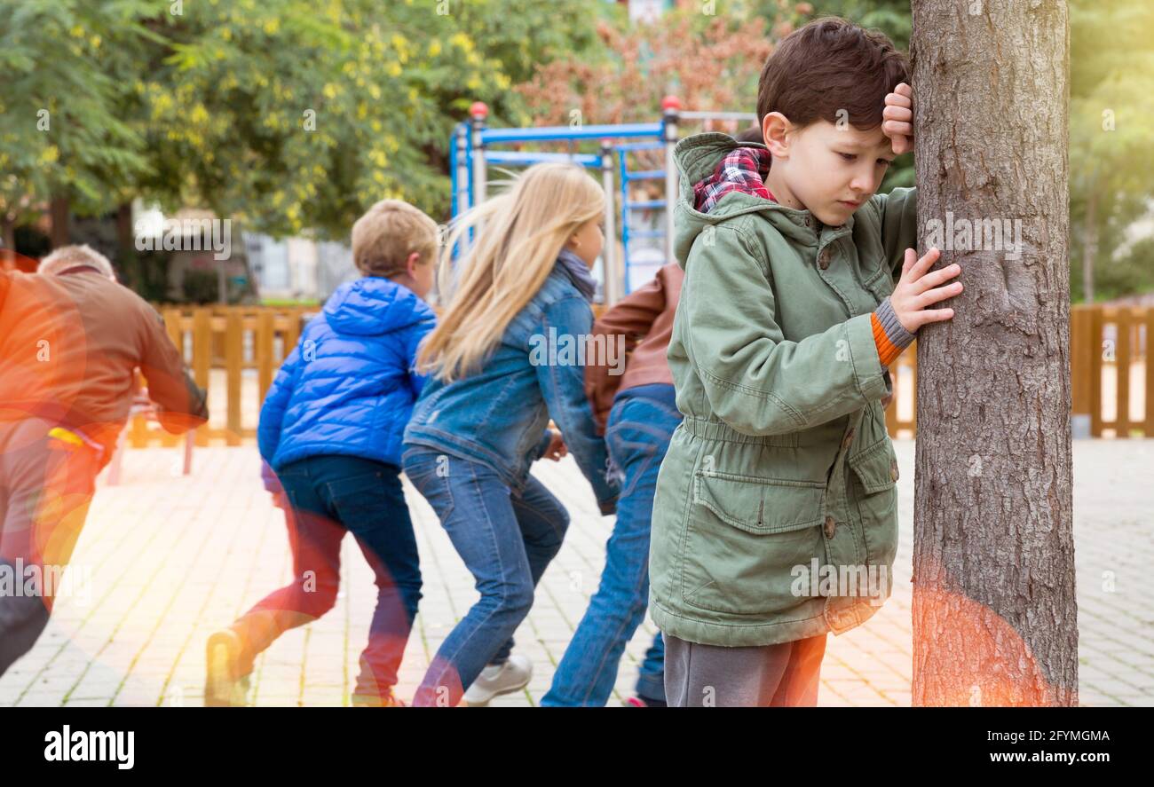 Kids playing hide and seek on the street Stock Photo - Alamy