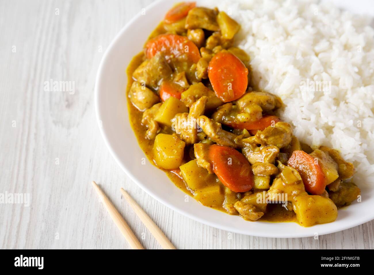 Homemade Japanese Chicken Curry on a white plate on a white wooden ...