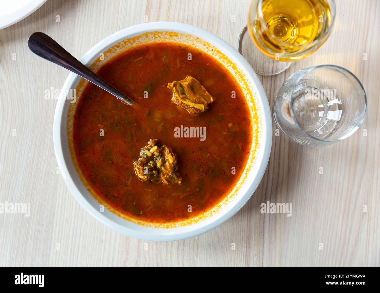 Georgian traditional cuisine, soup kharcho on a white ceramic plate ...