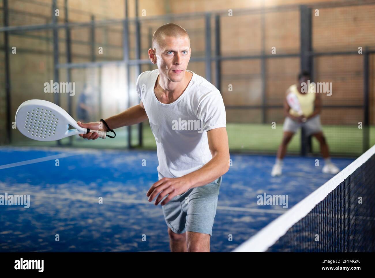 Man playing padel tennis on the padel court Stock Photo - Alamy