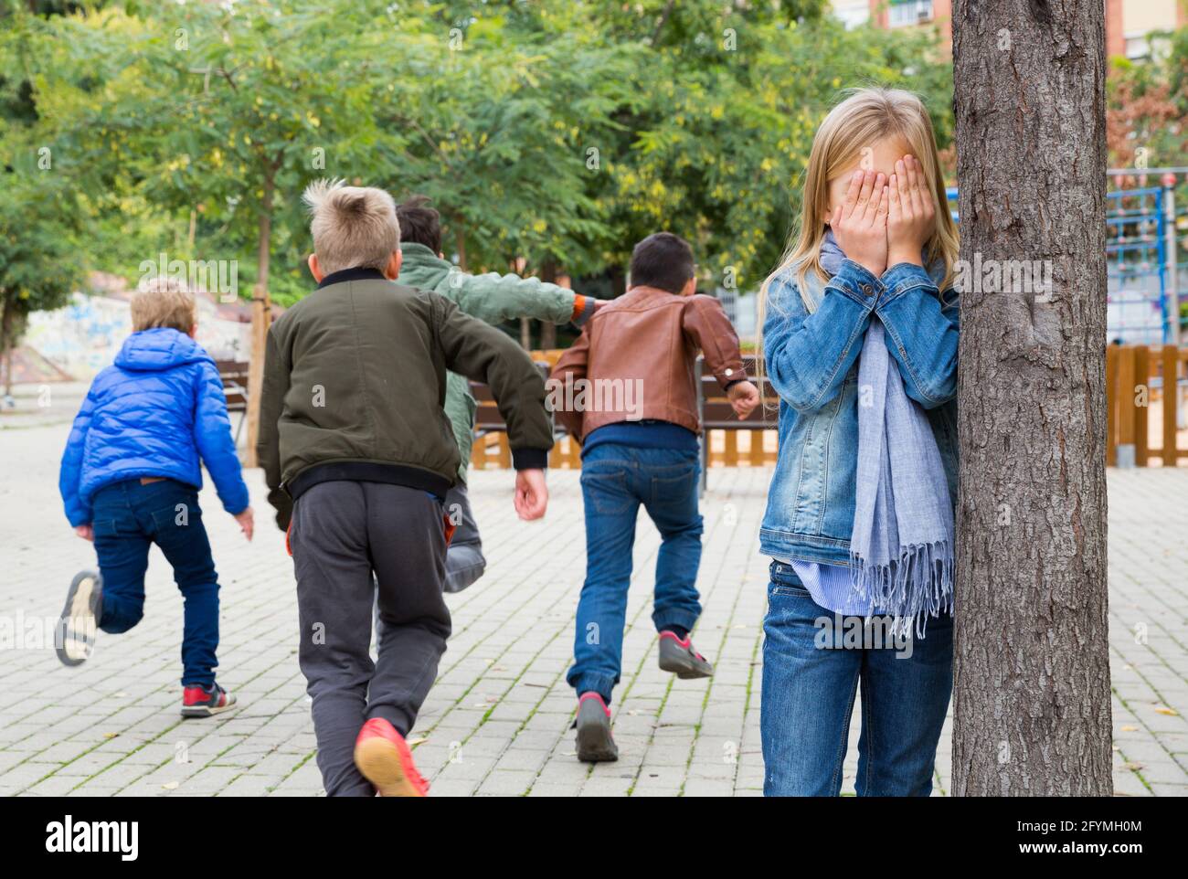 Kids playing hide and seek on the street Stock Photo - Alamy