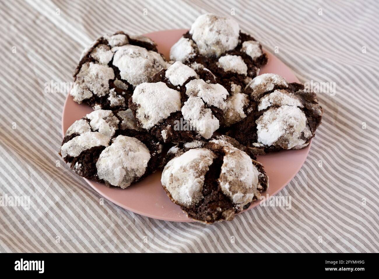 Homemade Chocolate Crinkle Cookies on a pink plate, side view Stock ...