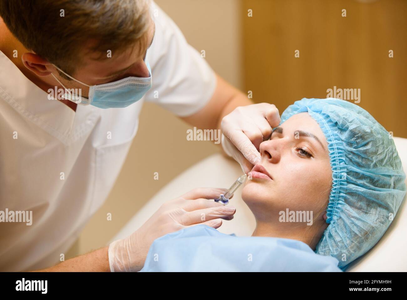 Woman makes rejuvenating facial injections procedure for lips ...