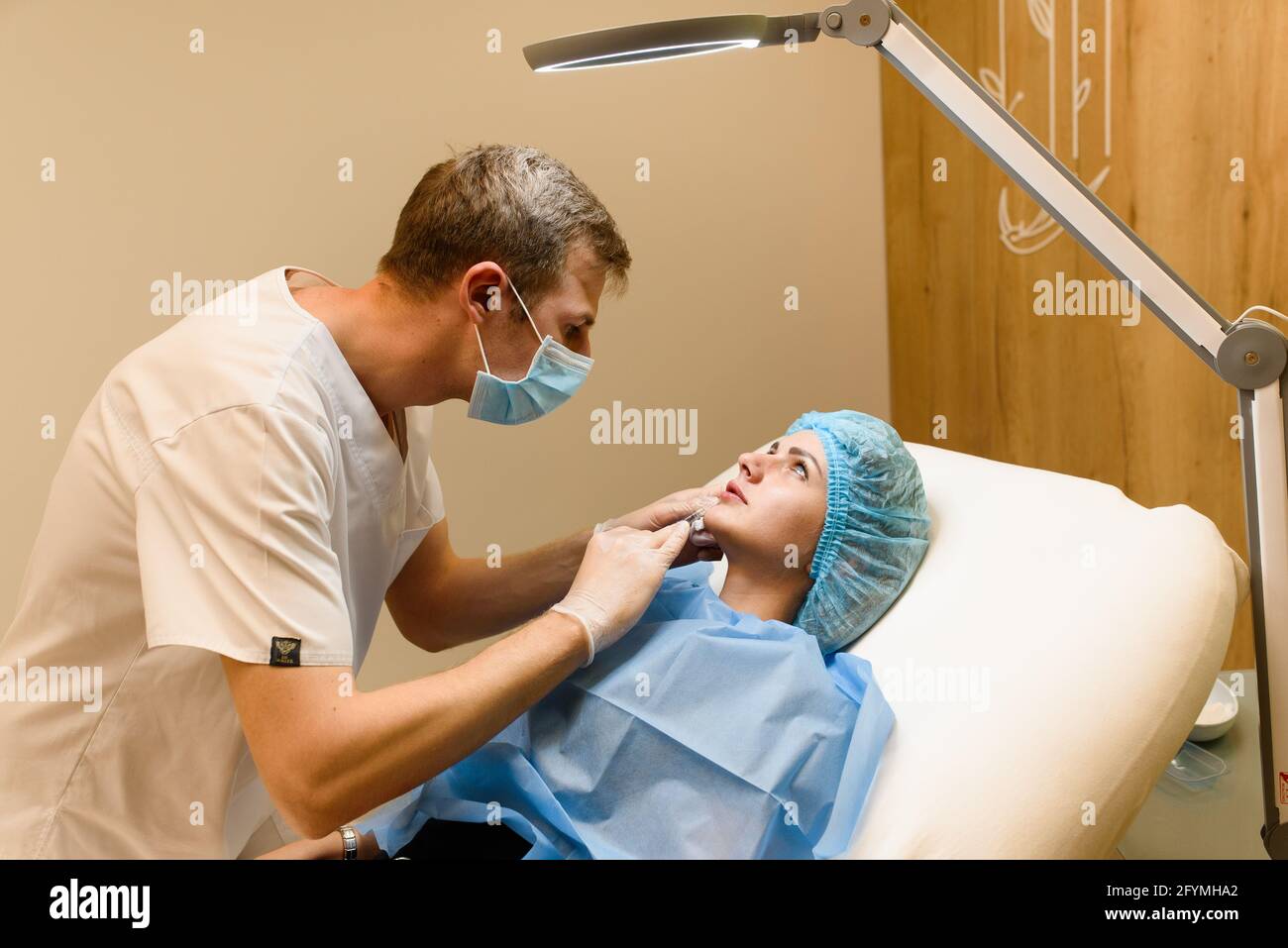 Woman makes rejuvenating facial injections procedure for lips ...