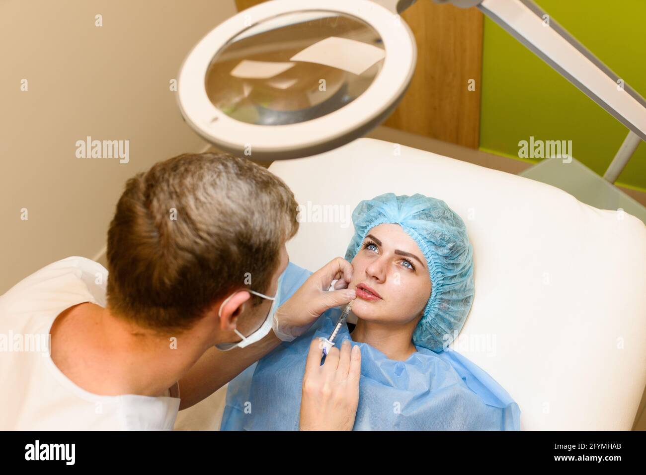 Woman makes rejuvenating facial injections procedure for lips ...