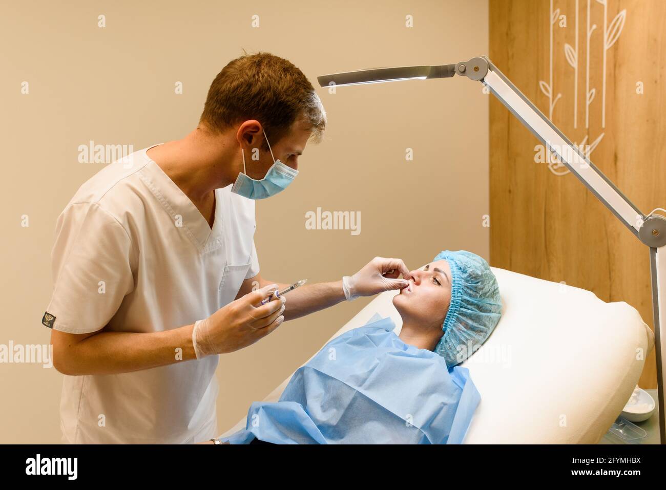 Woman makes rejuvenating facial injections procedure for lips ...