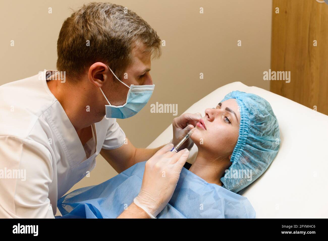 Woman makes rejuvenating facial injections procedure for lips ...
