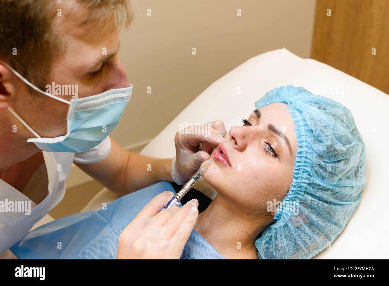 Woman makes rejuvenating facial injections procedure for lips ...