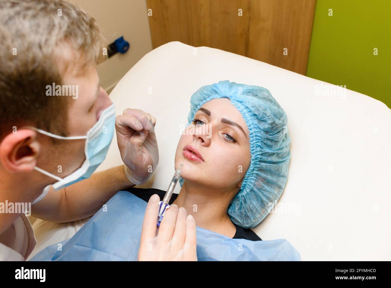 Woman makes rejuvenating facial injections procedure for lips ...