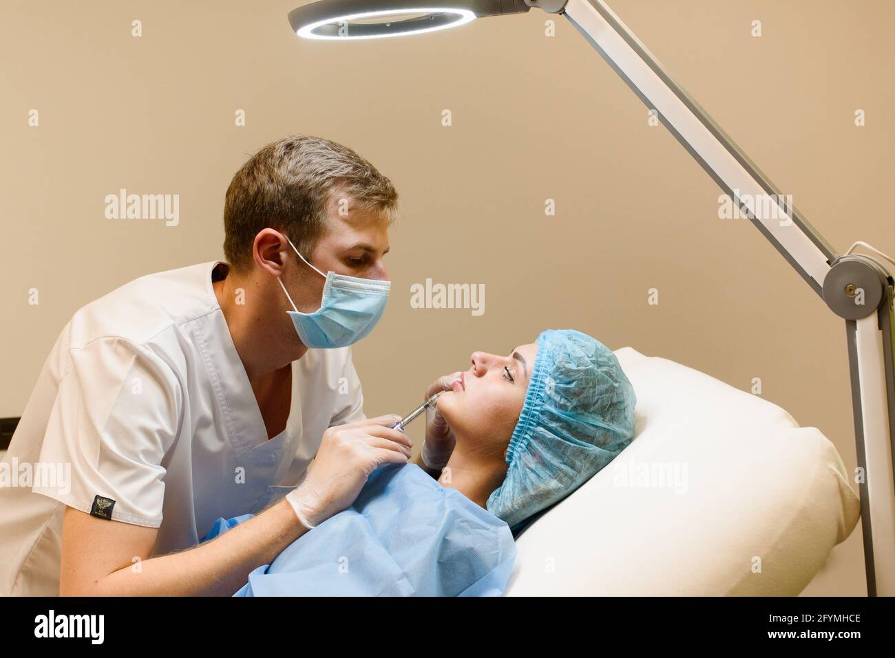 Woman makes rejuvenating facial injections procedure for lips ...