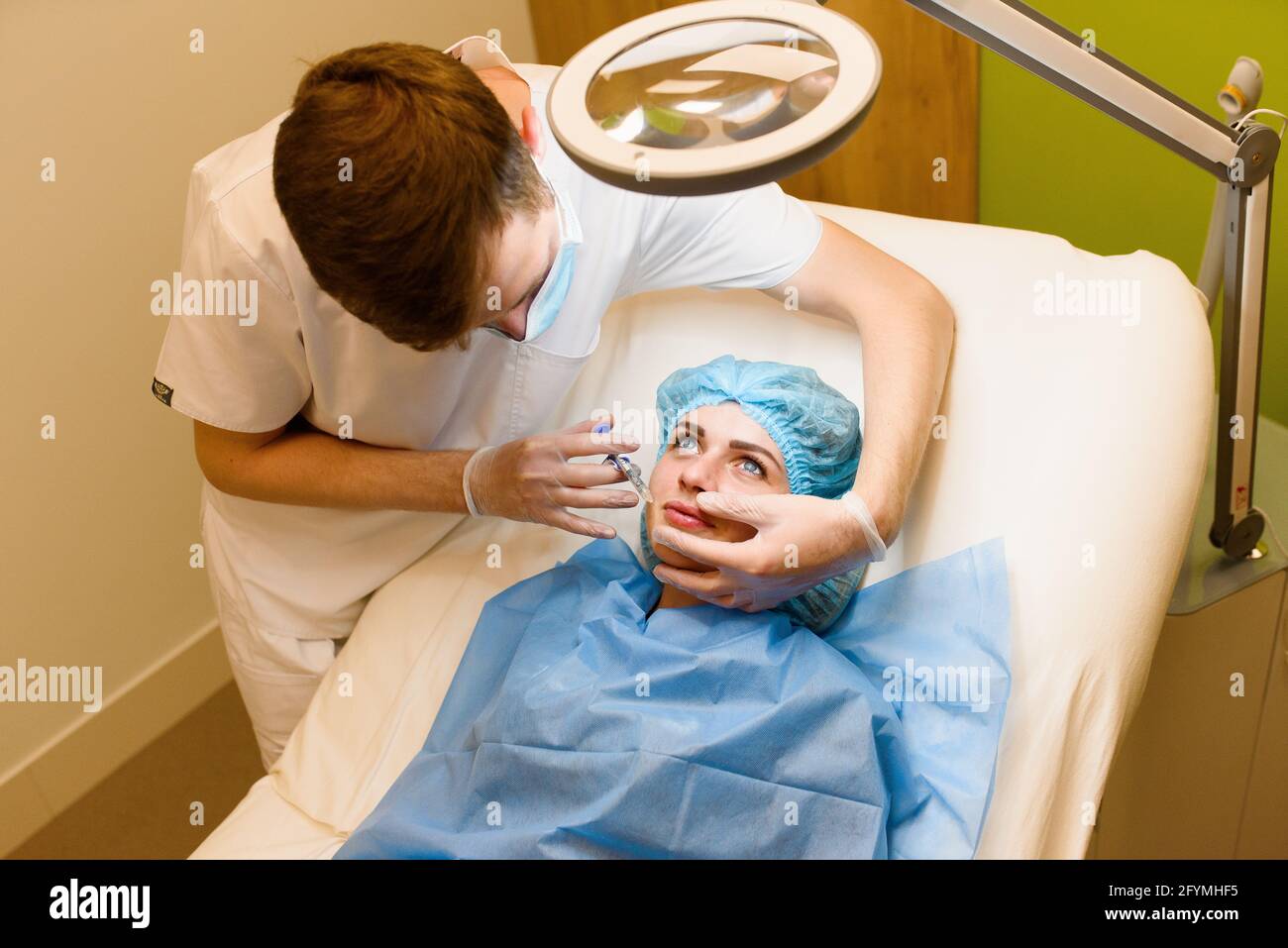 Woman makes rejuvenating facial injections procedure for lips ...