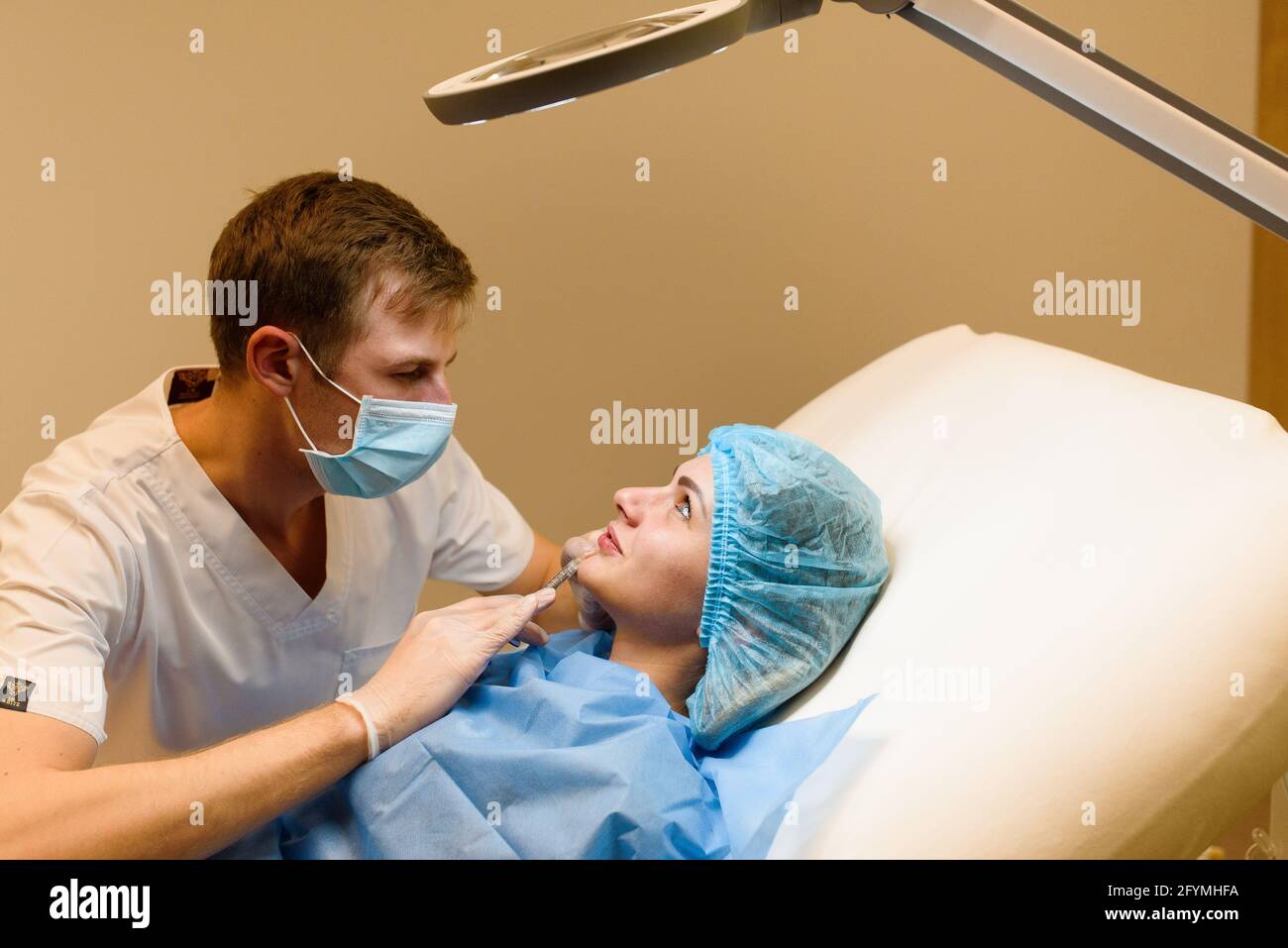 Woman makes rejuvenating facial injections procedure for lips ...