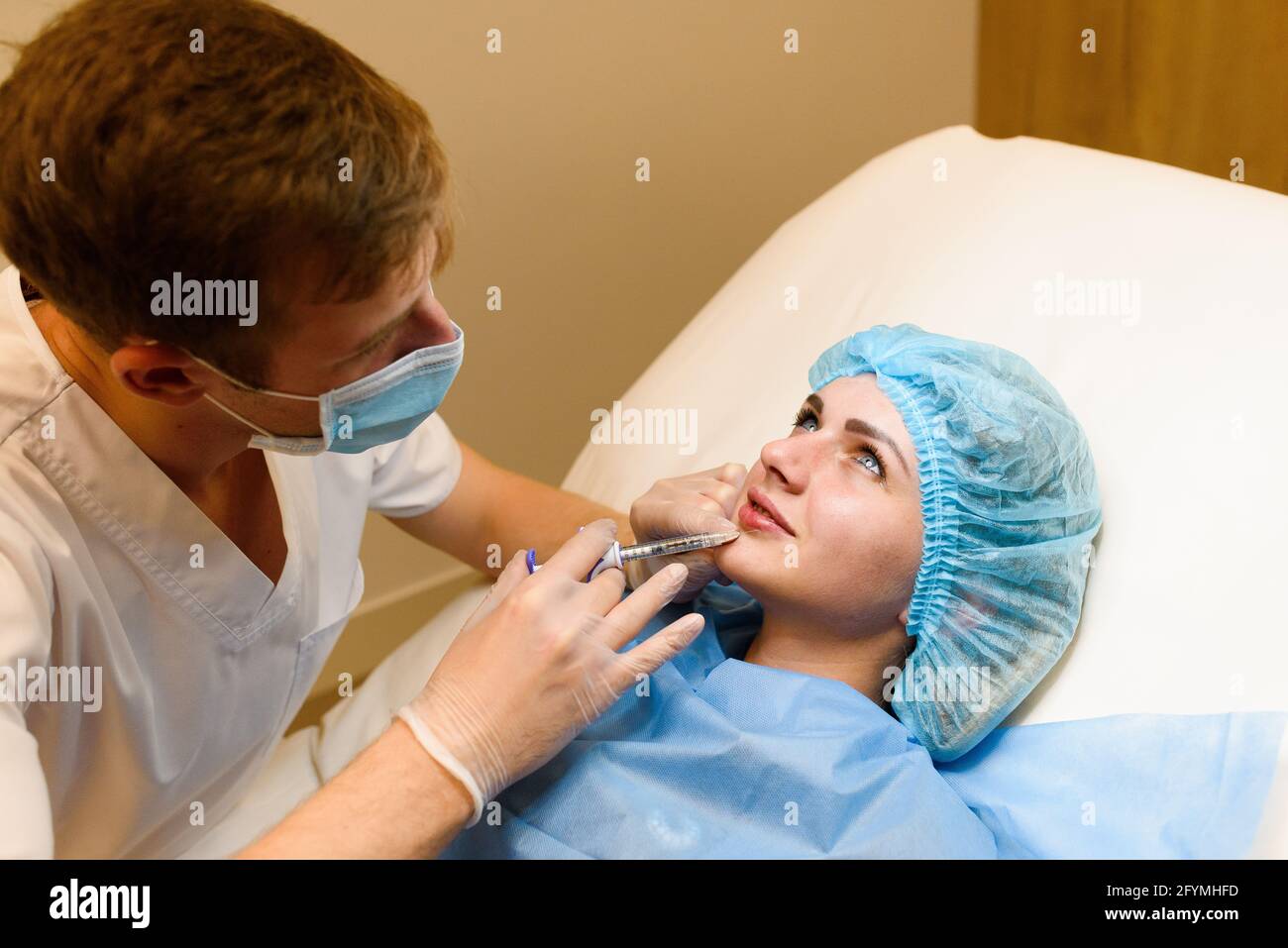 Woman makes rejuvenating facial injections procedure for lips ...