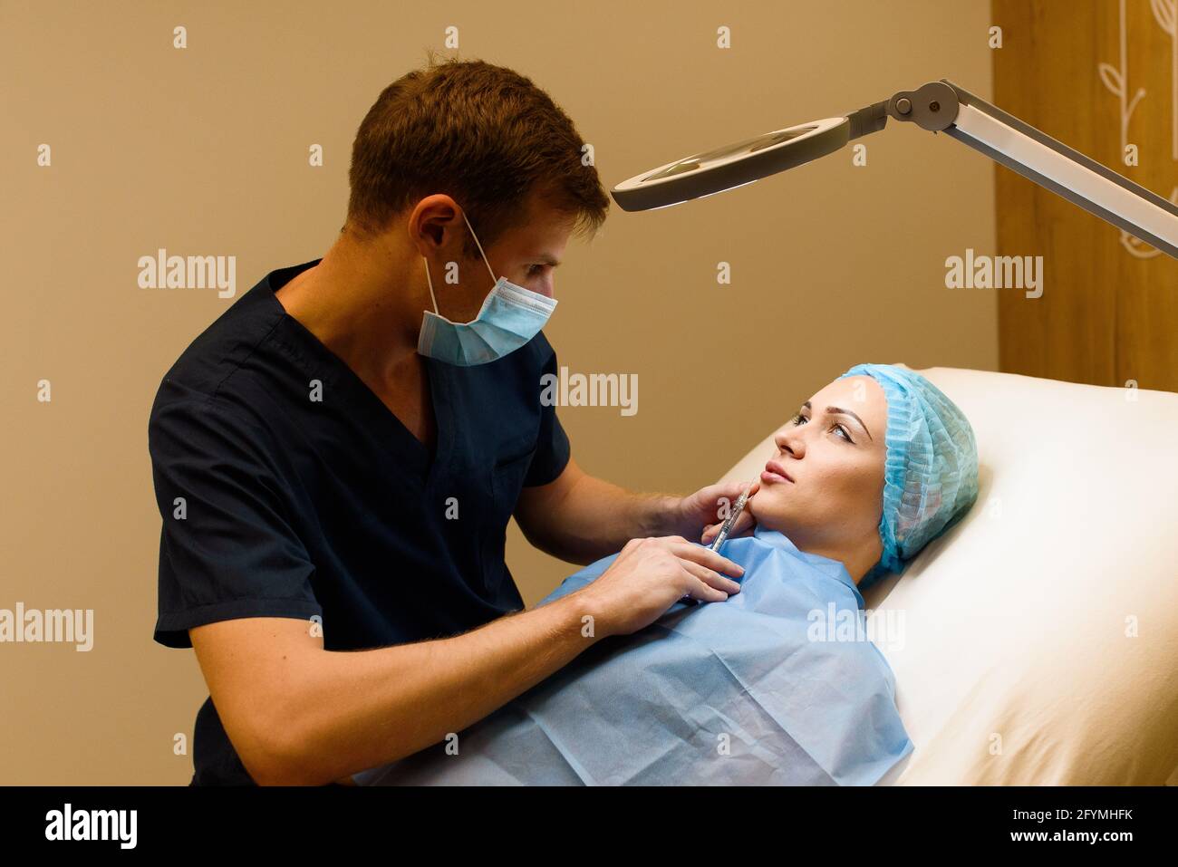 Woman makes rejuvenating facial injections procedure for lips ...
