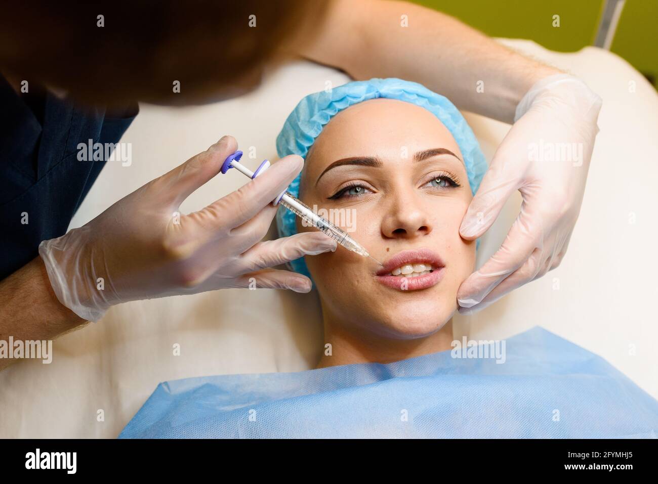 Woman makes rejuvenating facial injections procedure for lips ...