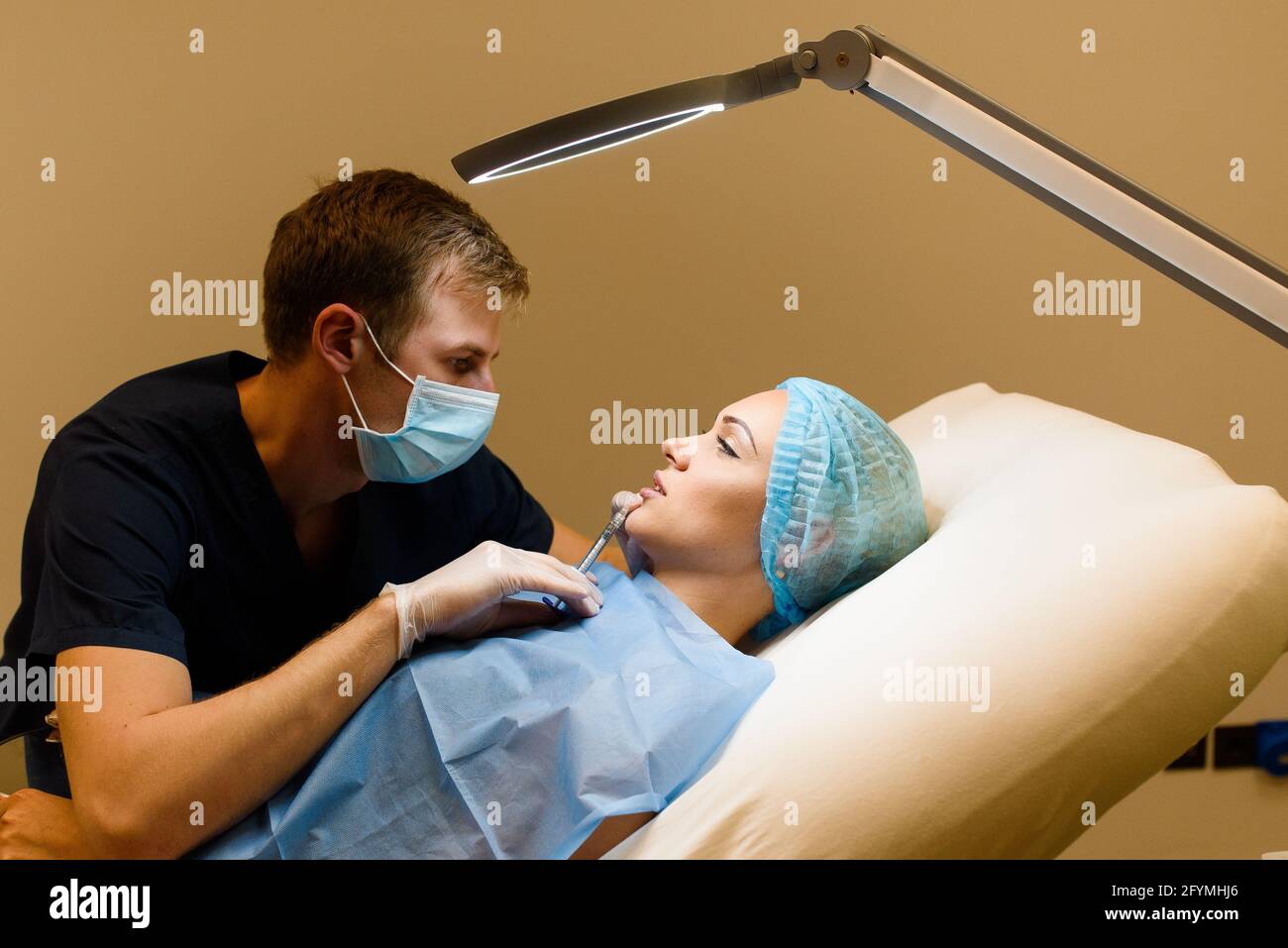 Woman makes rejuvenating facial injections procedure for lips ...